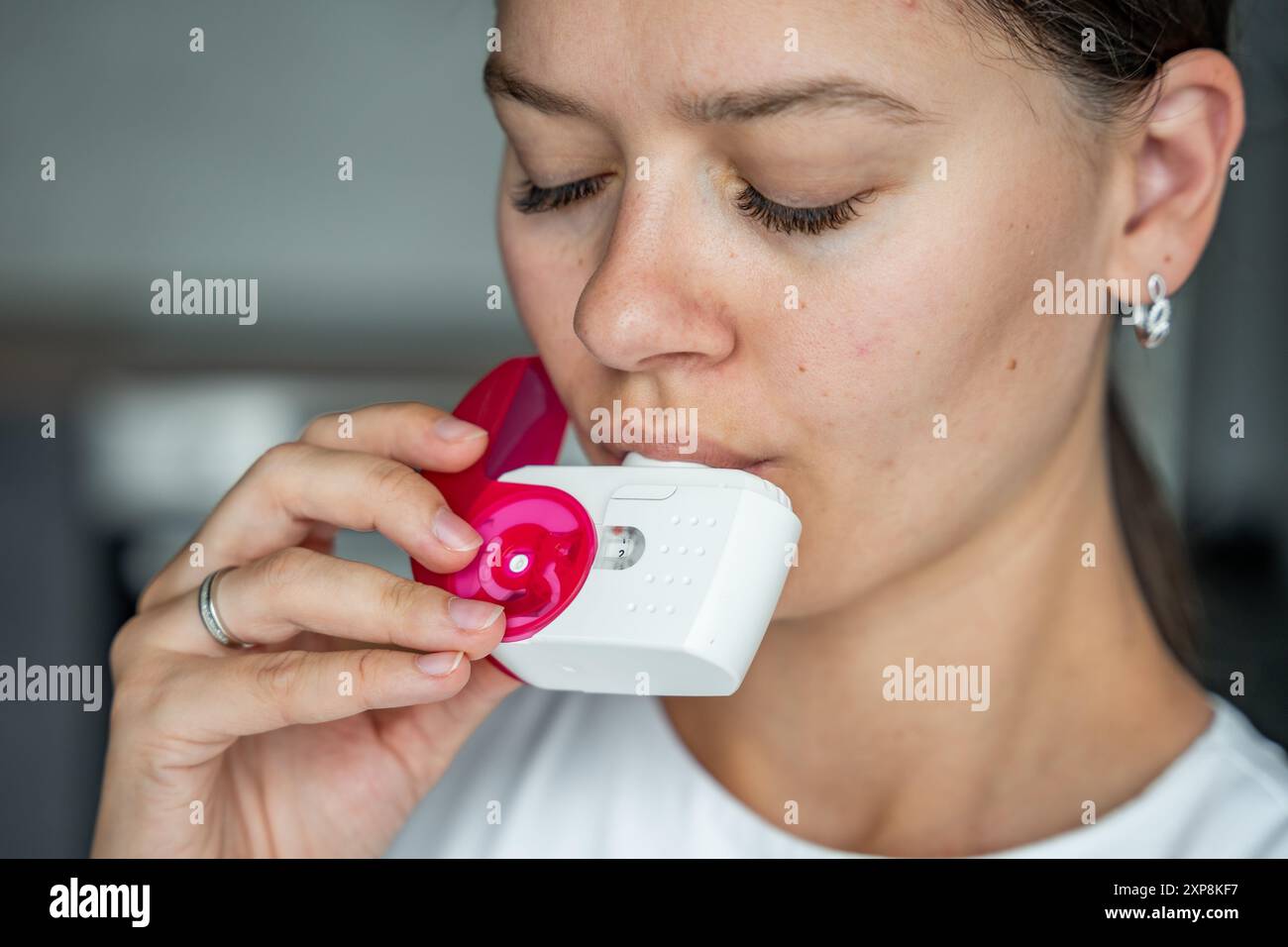 Close up view of woman using medicine dry powder inhaler for treatment ...