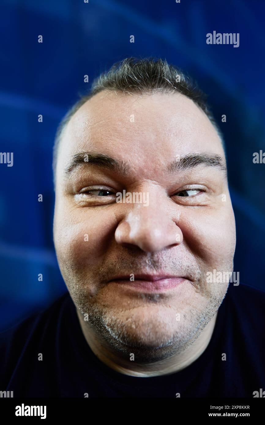 Playful grimace of large plump white man 47 years old on blue ...