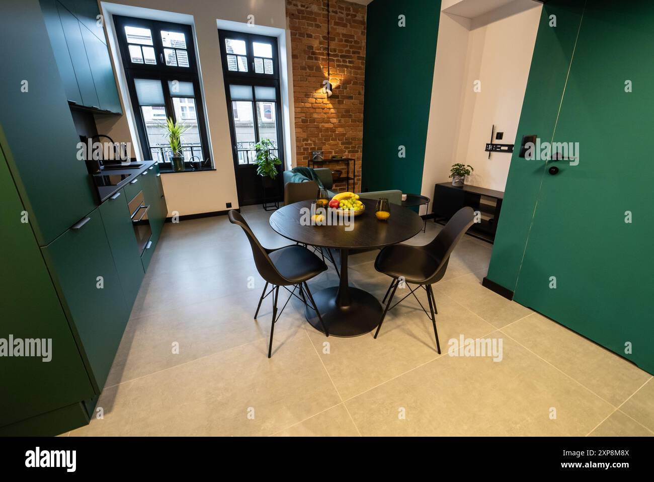 Stylish kitchen seamlessly connected to a cozy living room. Modern ...