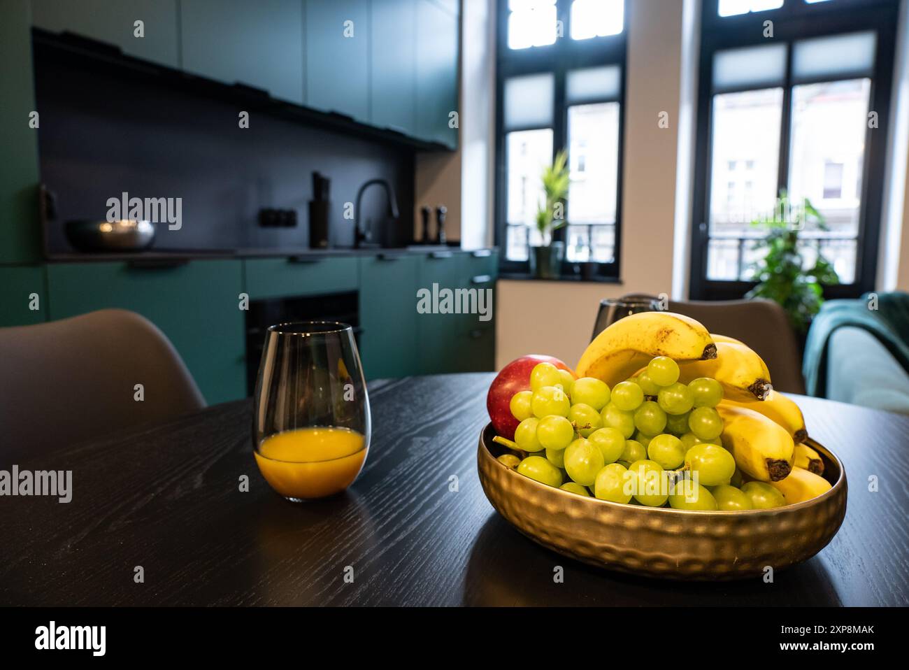 Fruits and juice on the table in the kitchen of a modern house. Kitchen ...