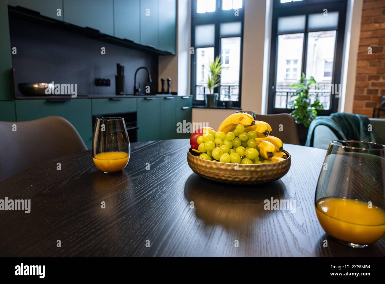 Fruits and juice on the table in the kitchen of a modern house. Kitchen ...