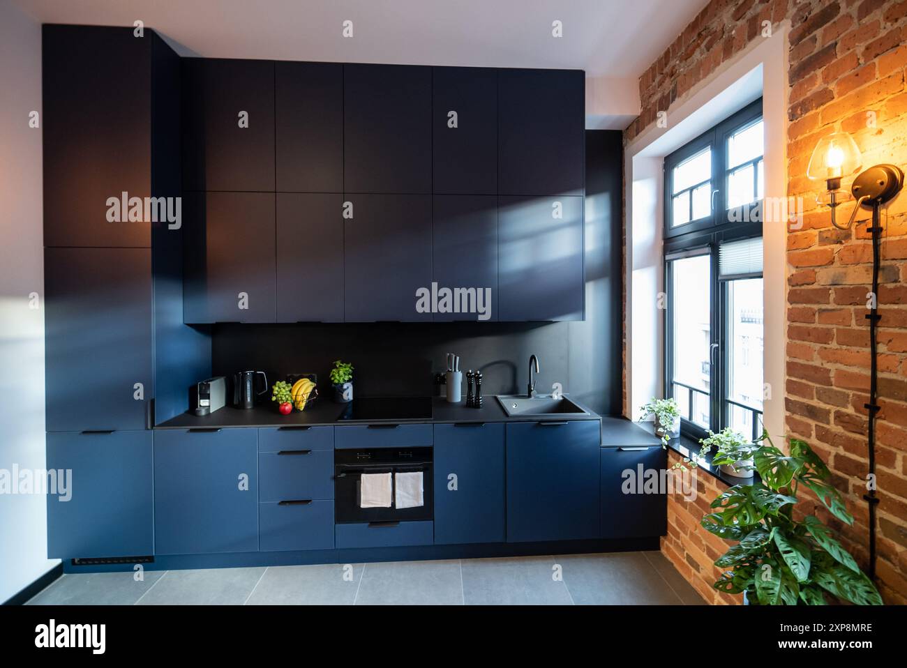 Modern furnished kitchen with household appliances and a dining room ...