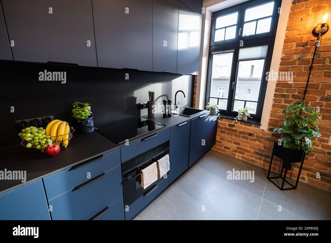 Modern furnished kitchen with household appliances and a dining room ...