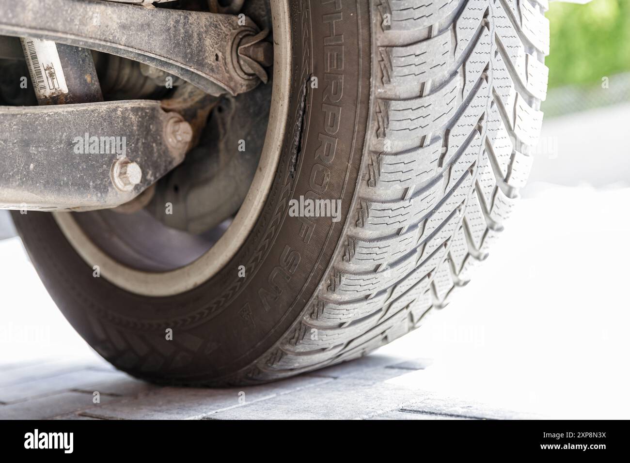Damaged car tire on alloy rim, long crack on the inside Stock Photo - Alamy