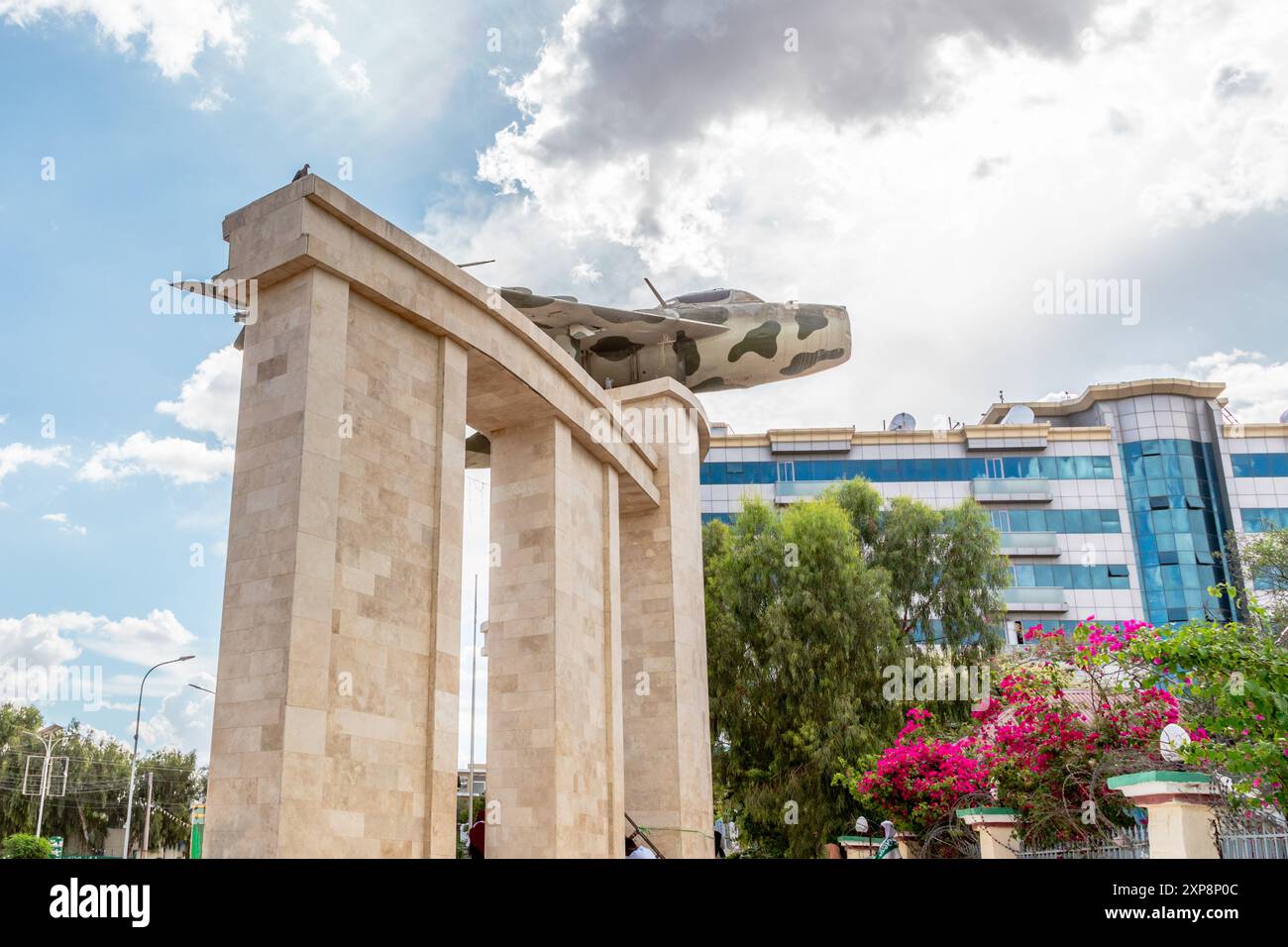 Old war memorial with soviet jet fighter and modern buildings in the ...