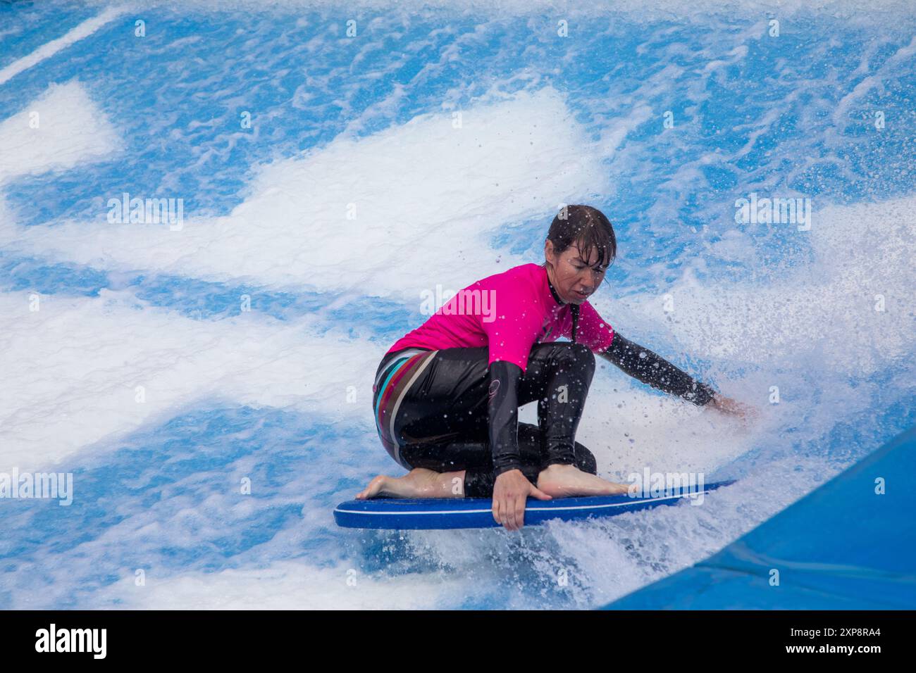 Female surfer of the Anthem of the Seas, Flowrider surf simulator Stock ...