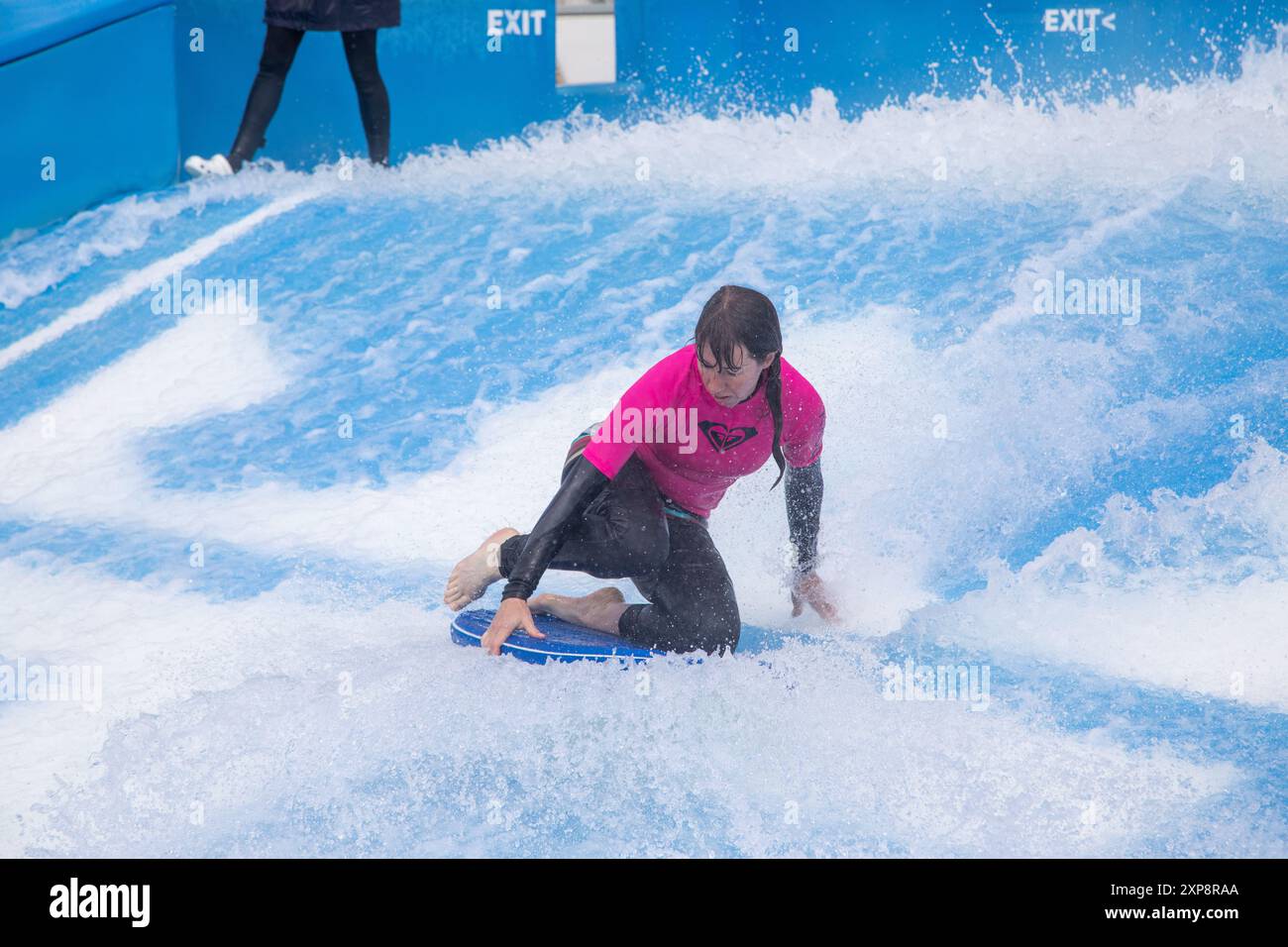 Female surfer of the Anthem of the Seas, Flowrider surf simulator Stock ...
