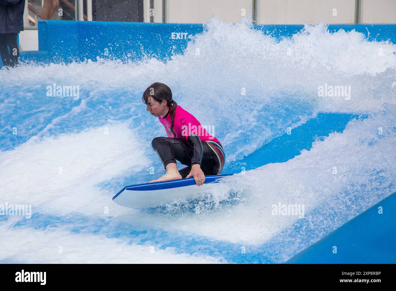 Female surfer of the Anthem of the Seas, Flowrider surf simulator Stock ...