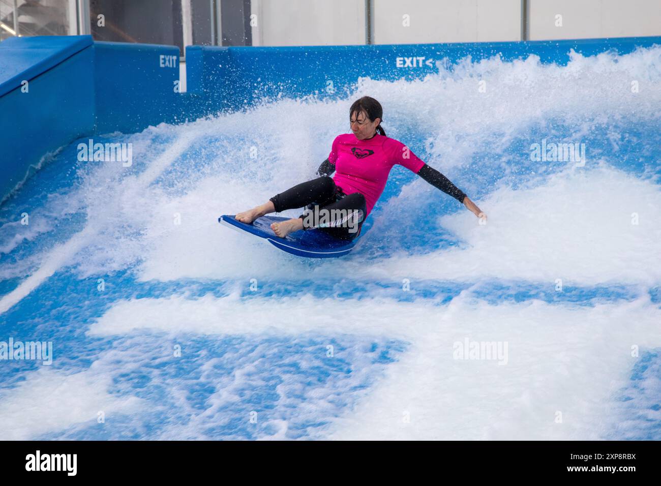 Female surfer of the Anthem of the Seas, Flowrider surf simulator Stock ...