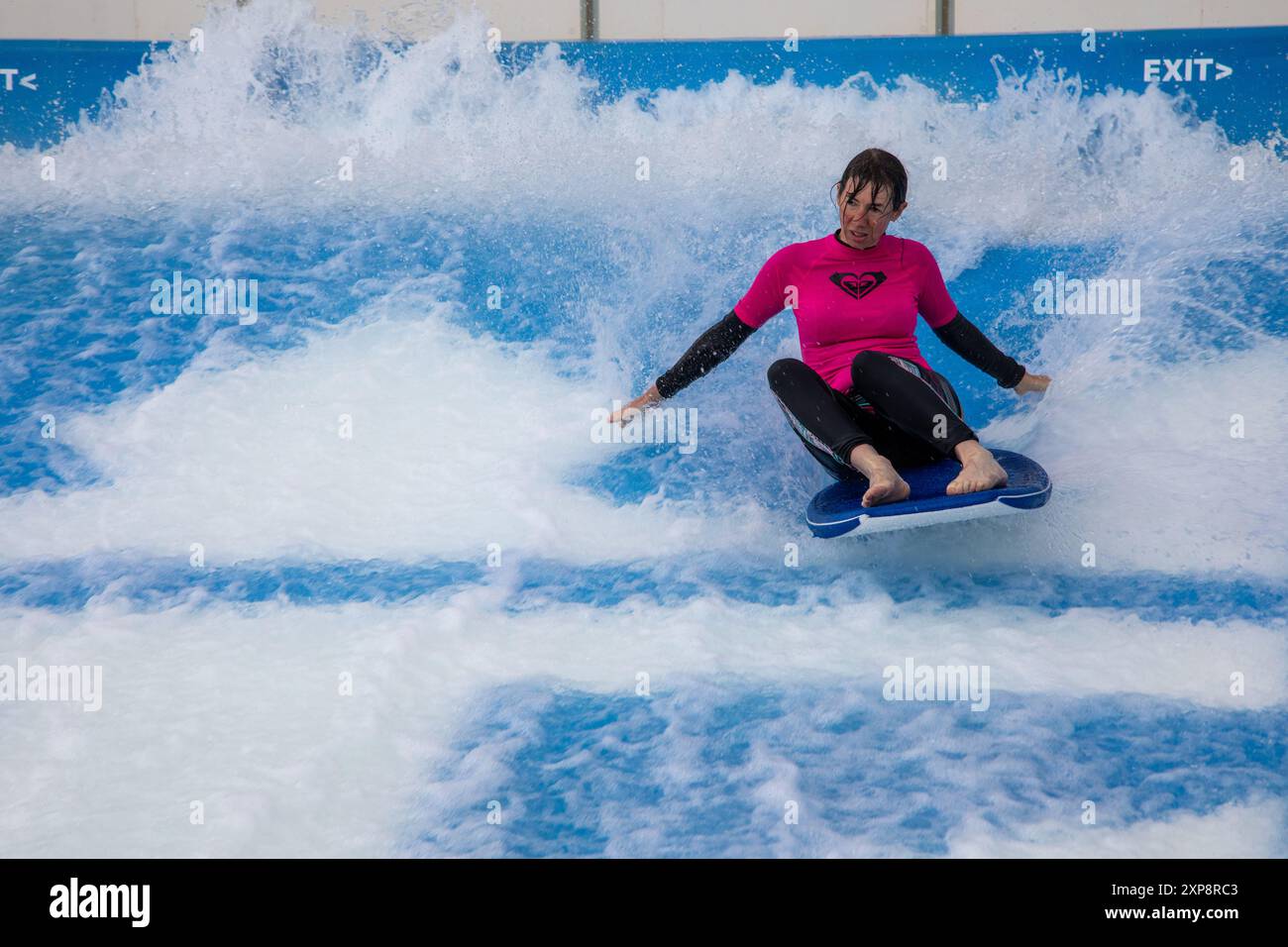 Female surfer of the Anthem of the Seas, Flowrider surf simulator Stock ...
