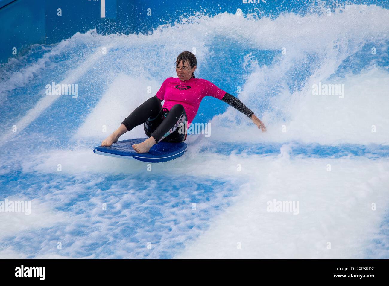 Female surfer of the Anthem of the Seas, Flowrider surf simulator Stock ...