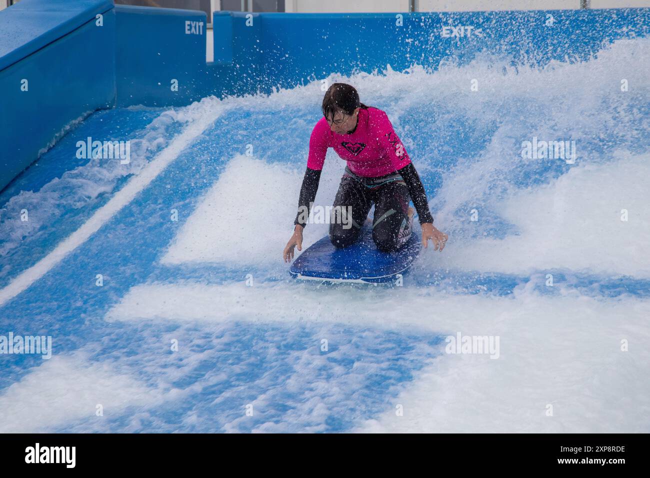 Female surfer of the Anthem of the Seas, Flowrider surf simulator Stock ...