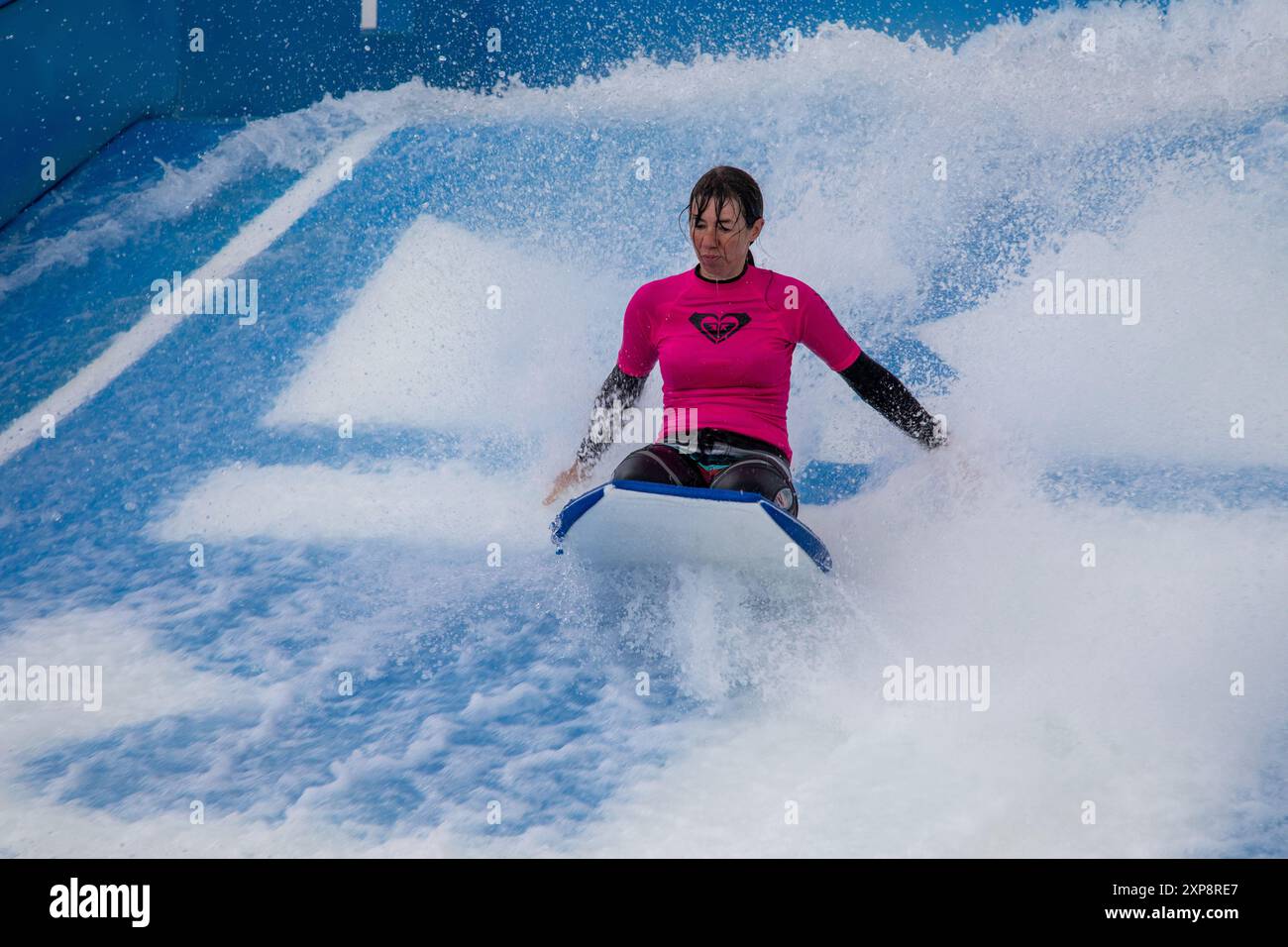 Female surfer of the Anthem of the Seas, Flowrider surf simulator Stock ...