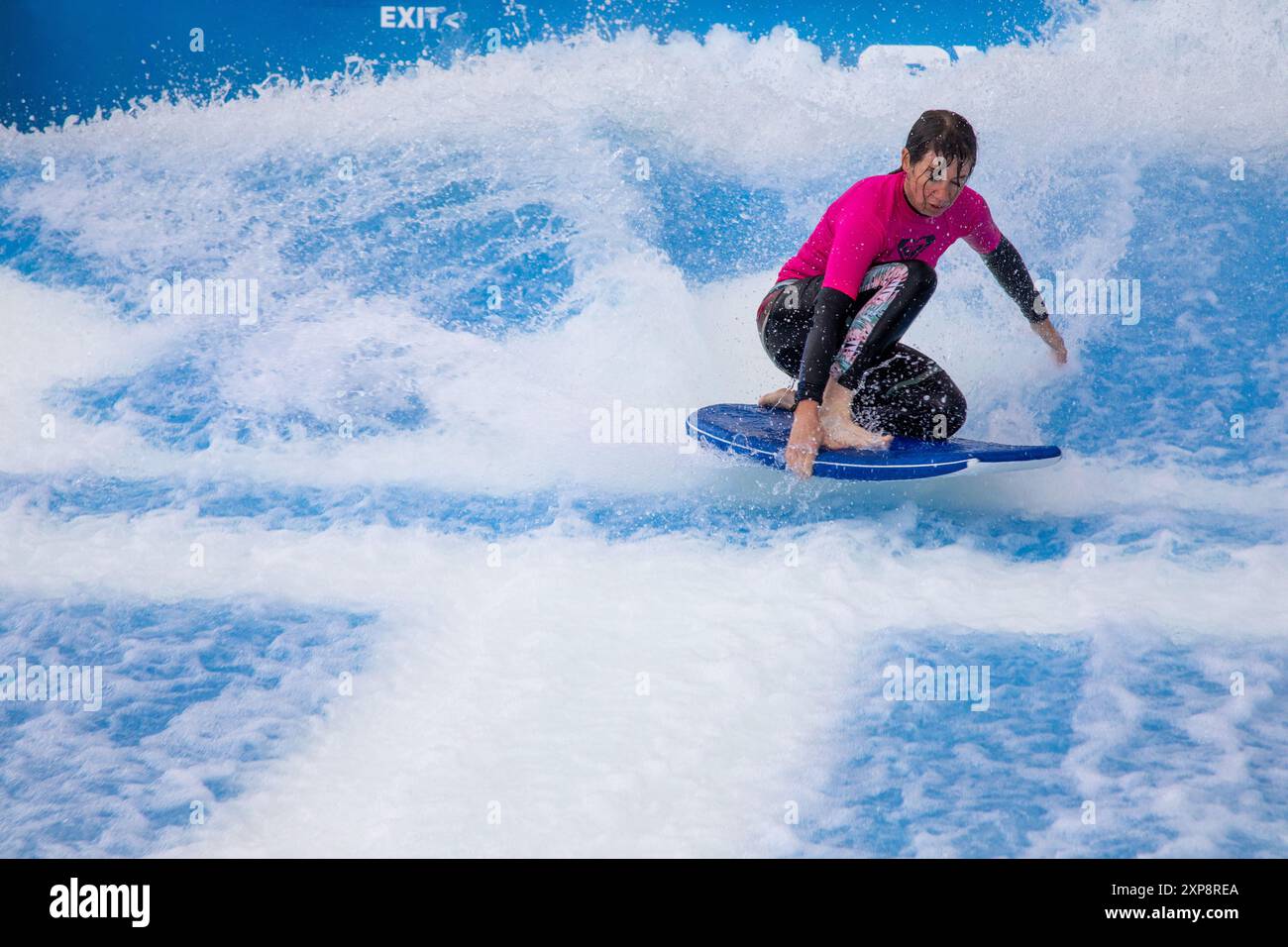 Female surfer of the Anthem of the Seas, Flowrider surf simulator Stock ...