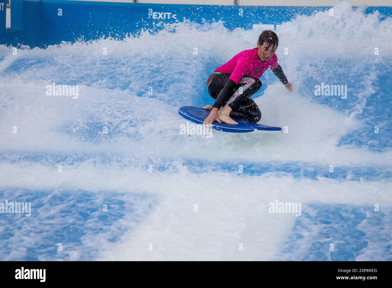 Female surfer of the Anthem of the Seas, Flowrider surf simulator Stock ...