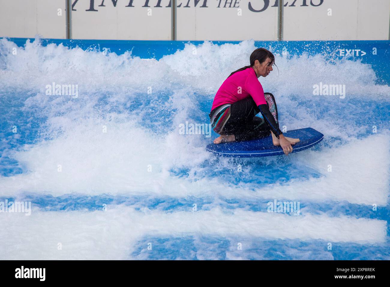 Female surfer of the Anthem of the Seas, Flowrider surf simulator Stock ...