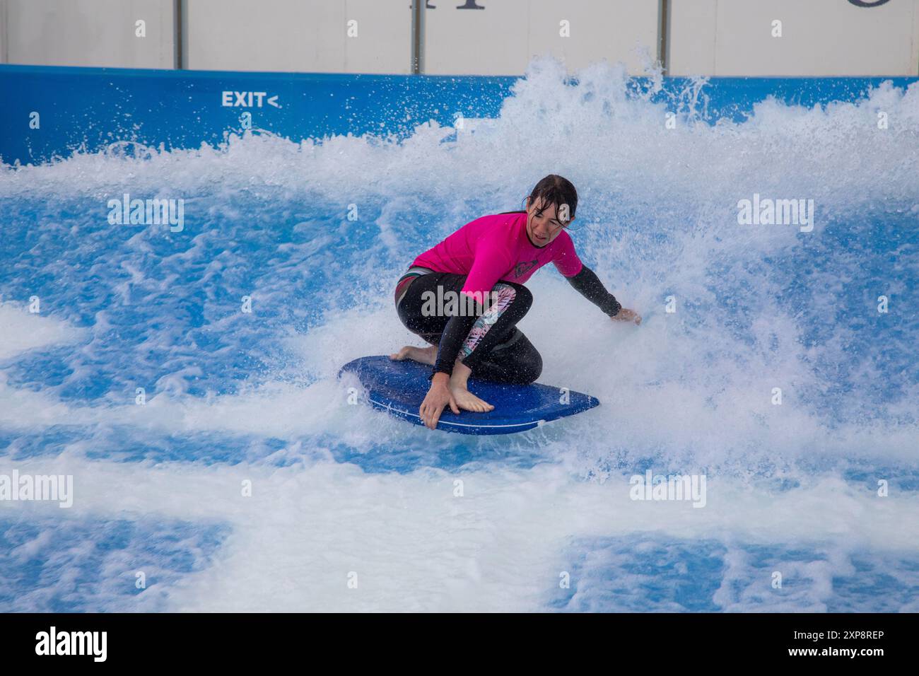 Female surfer of the Anthem of the Seas, Flowrider surf simulator Stock ...