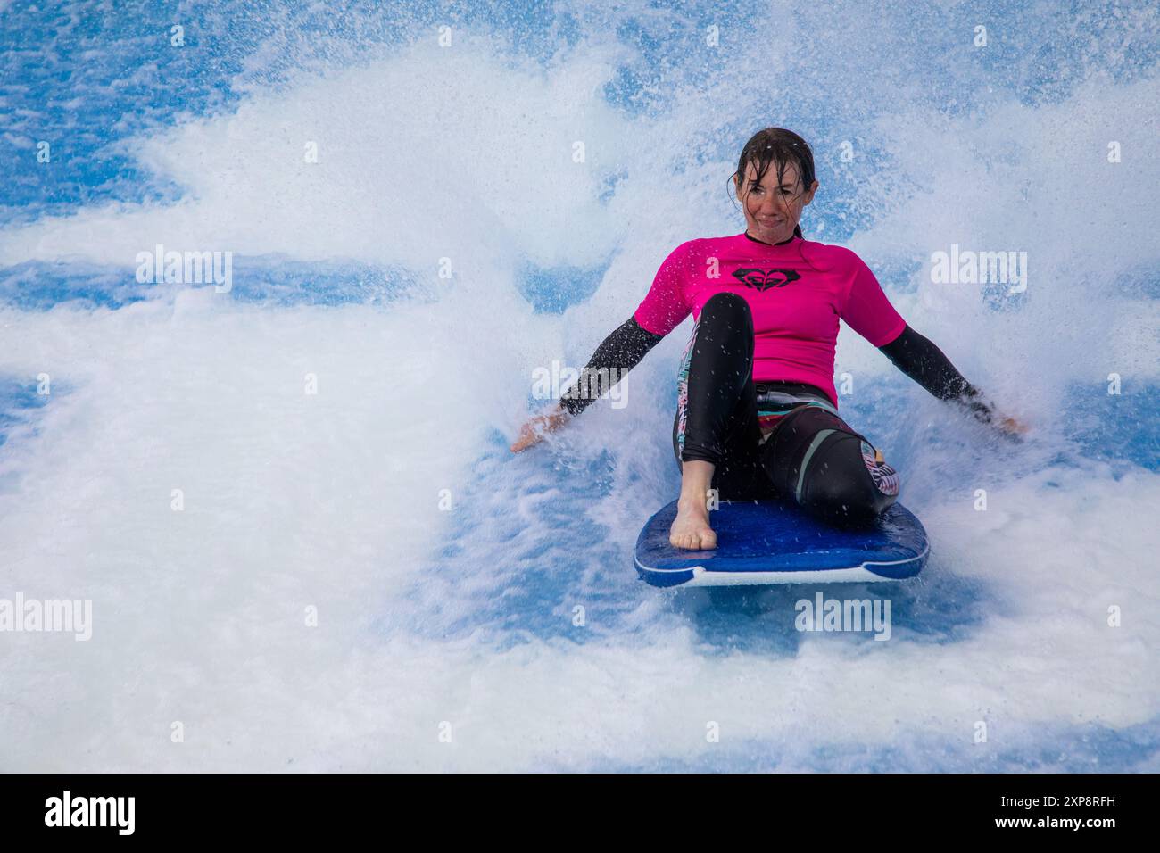 Female surfer of the Anthem of the Seas, Flowrider surf simulator Stock Photo - Alamy