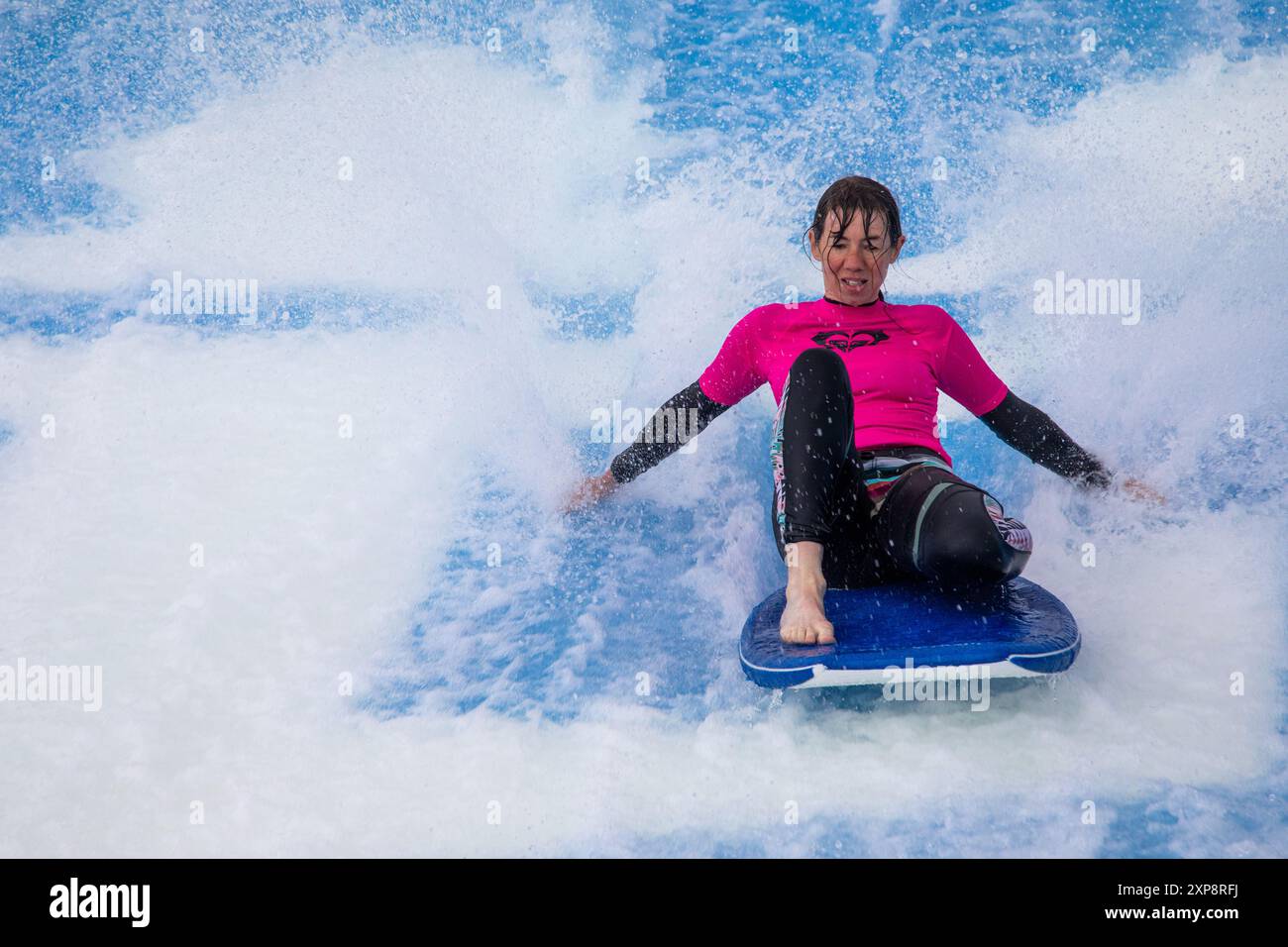 Female surfer of the Anthem of the Seas, Flowrider surf simulator Stock ...