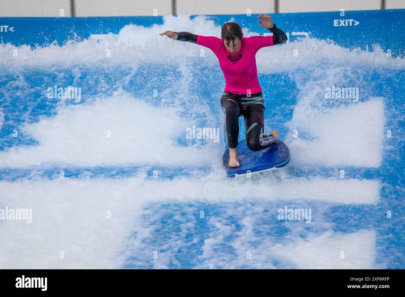 Female surfer of the Anthem of the Seas, Flowrider surf simulator Stock ...