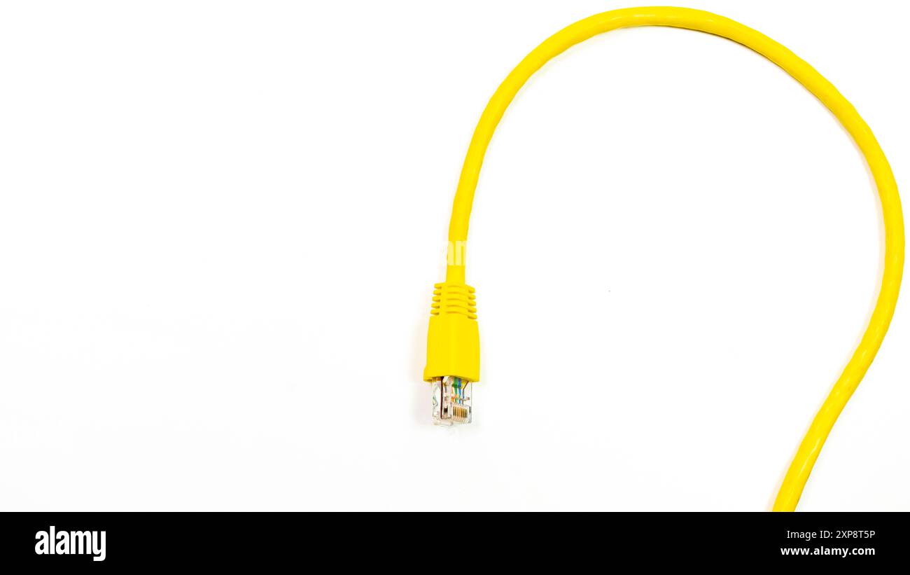 A yellow internet cables with a white background Stock Photo - Alamy