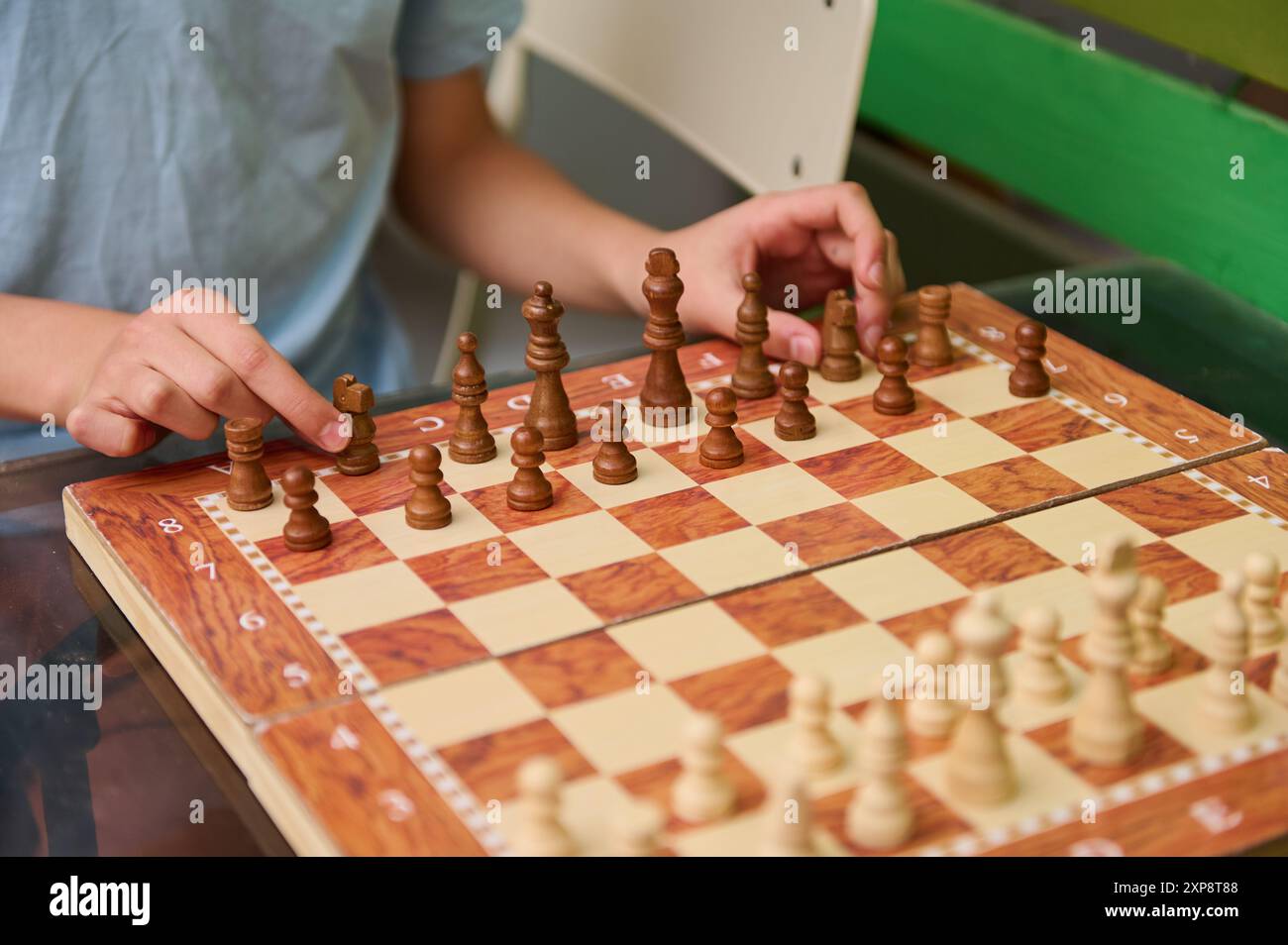Focused hands engaged in a strategic and thoughtful chess game ...
