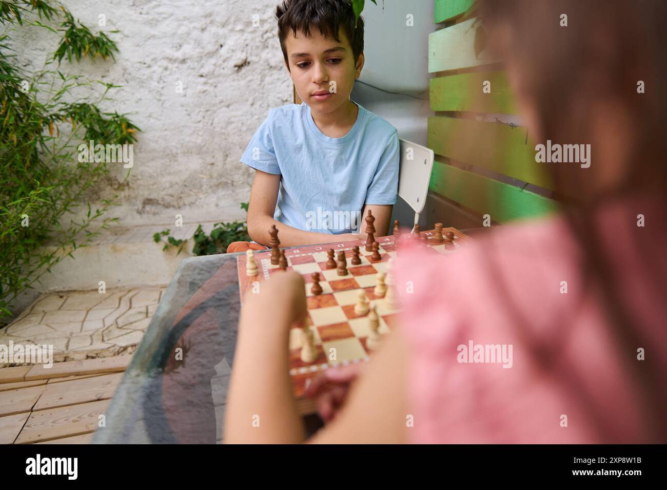 Two children playing chess outdoors, highlighting strategic thinking ...