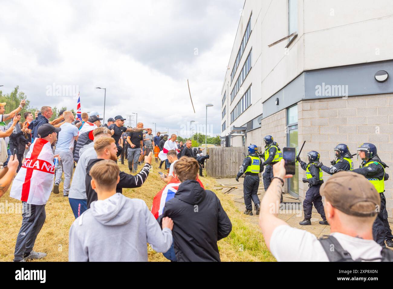 Rotherham, UK. 04 AUG, 2024. Rioters throw wood towards the hotel and ...
