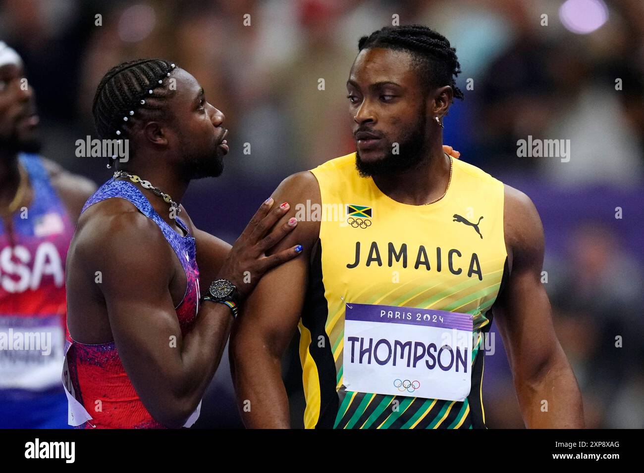 Noah Lyles, of the United States, left, after winning the men's 100 ...