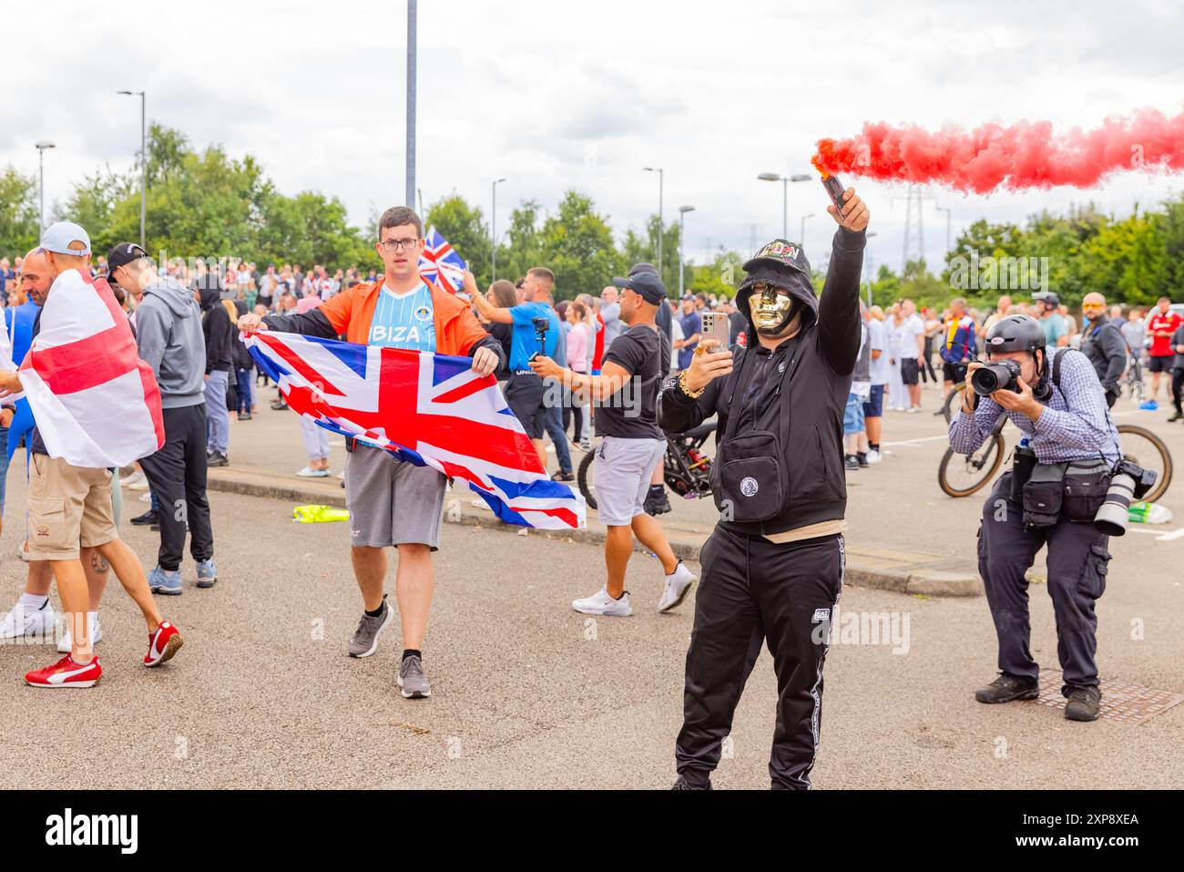 Rotherham, UK. 04 AUG, 2024. Protestor with a flare as hundreds of ...