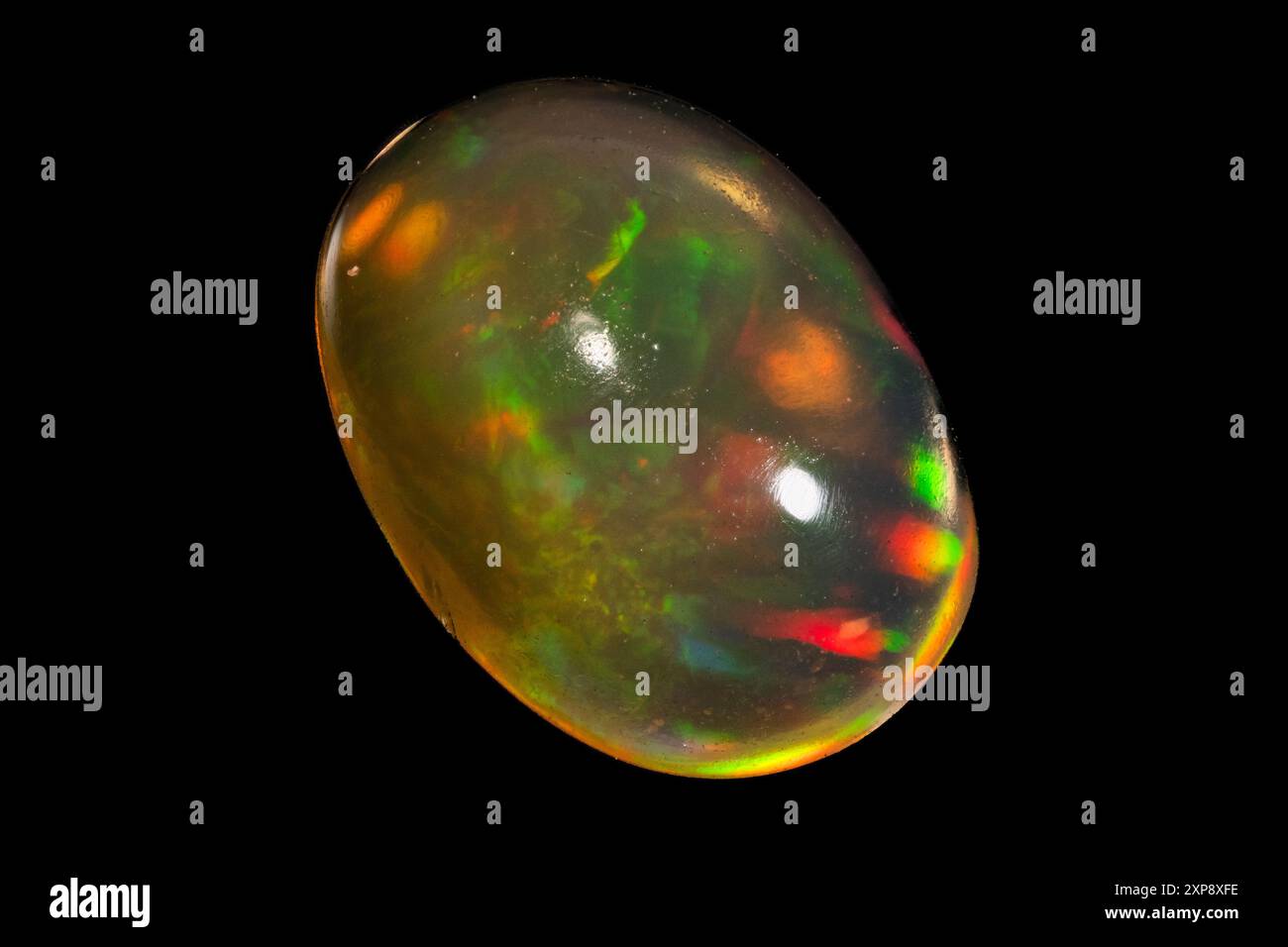 natural rainbow opal gem isolated on the black background Stock Photo ...