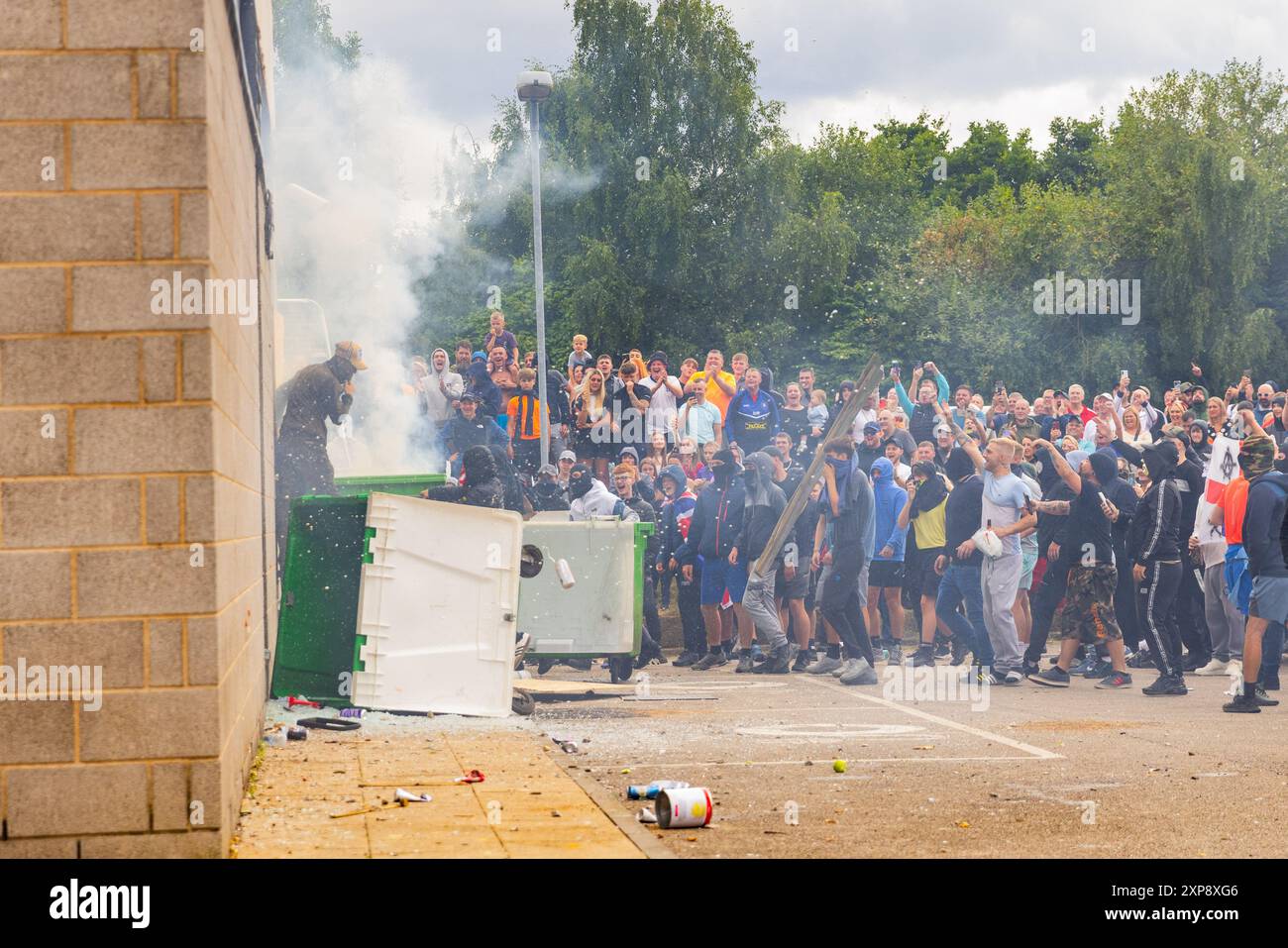 Rotherham, UK. 04 AUG, 2024. Rioters start a fire in the smashed up ...