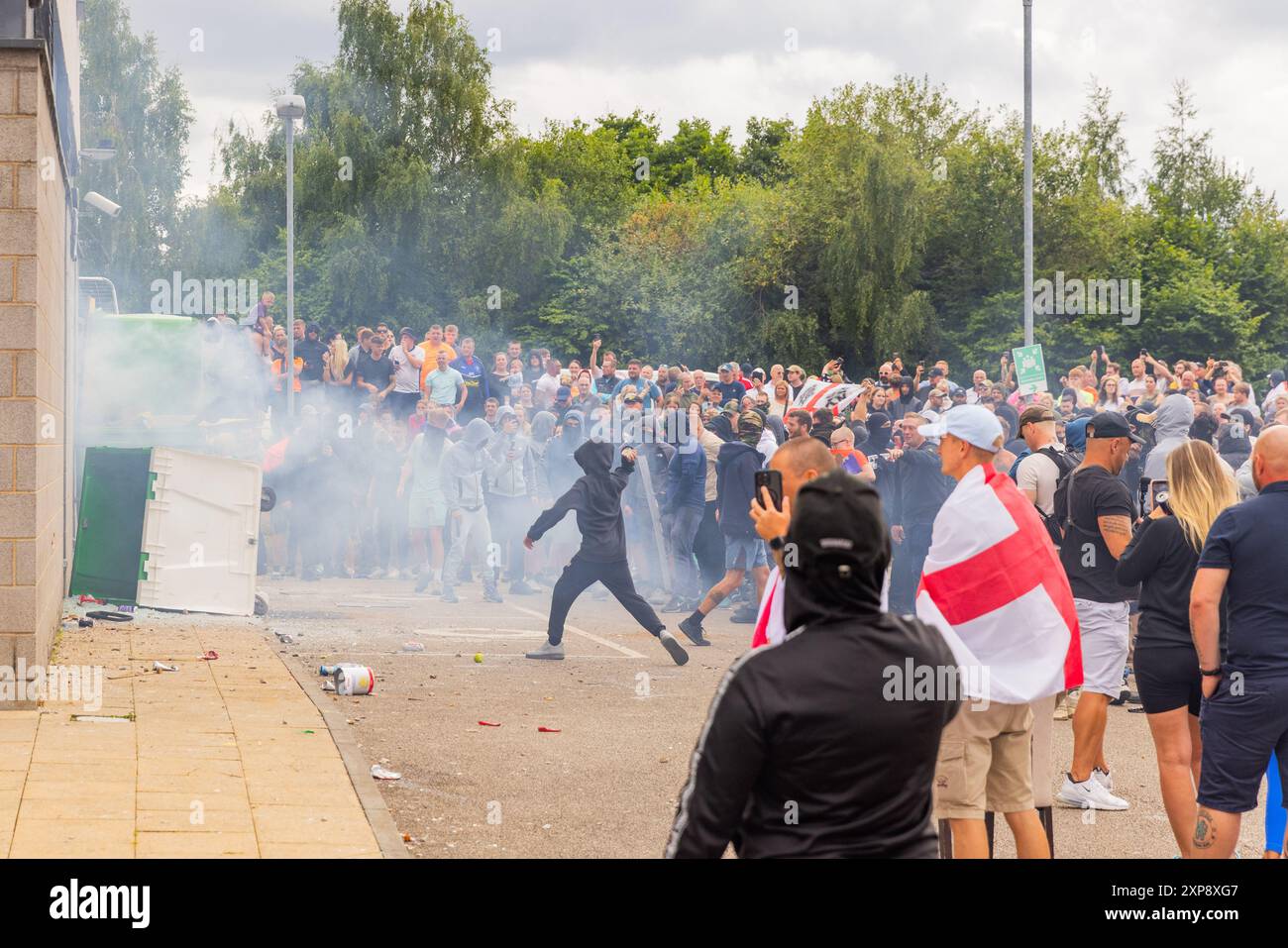 Rotherham, UK. 04 AUG, 2024. Rioters start a fire in the smashed up ...