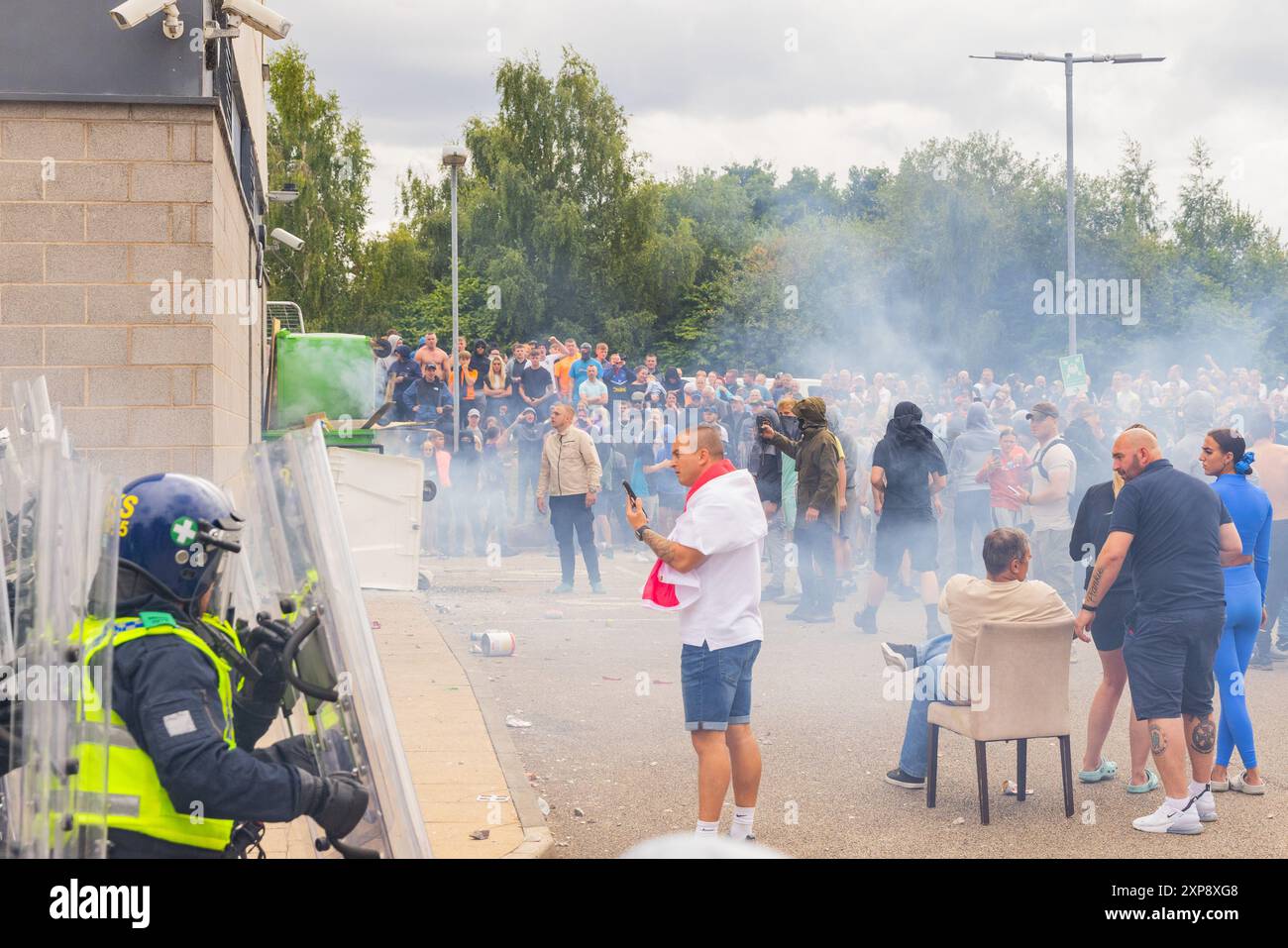 Rotherham, UK. 04 AUG, 2024. Rioters start a fire in the smashed up ...