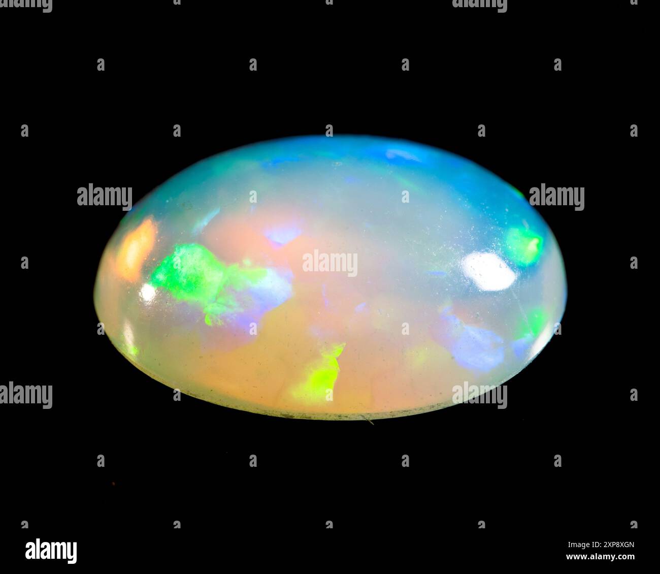 natural rainbow opal gem isolated on the black background Stock Photo ...