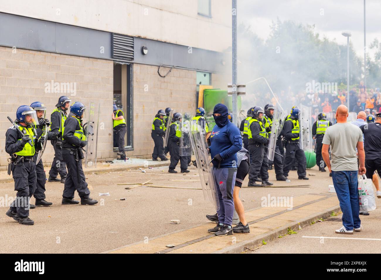 Rotherham, UK. 04 AUG, 2024. Rioter with a stolen riot shield as people ...
