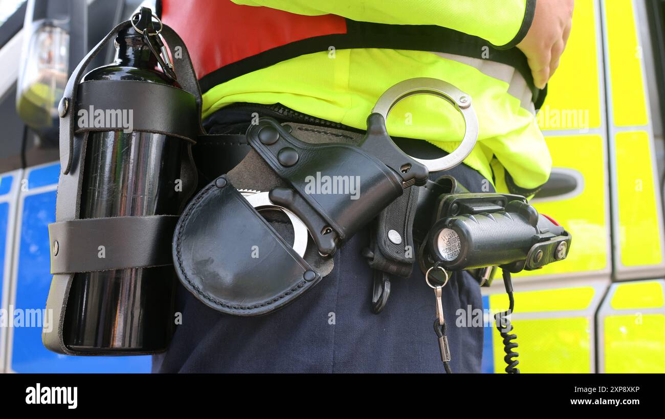 Handcuffs and PAVA spray on a policeman's duty belt Stock Photo - Alamy