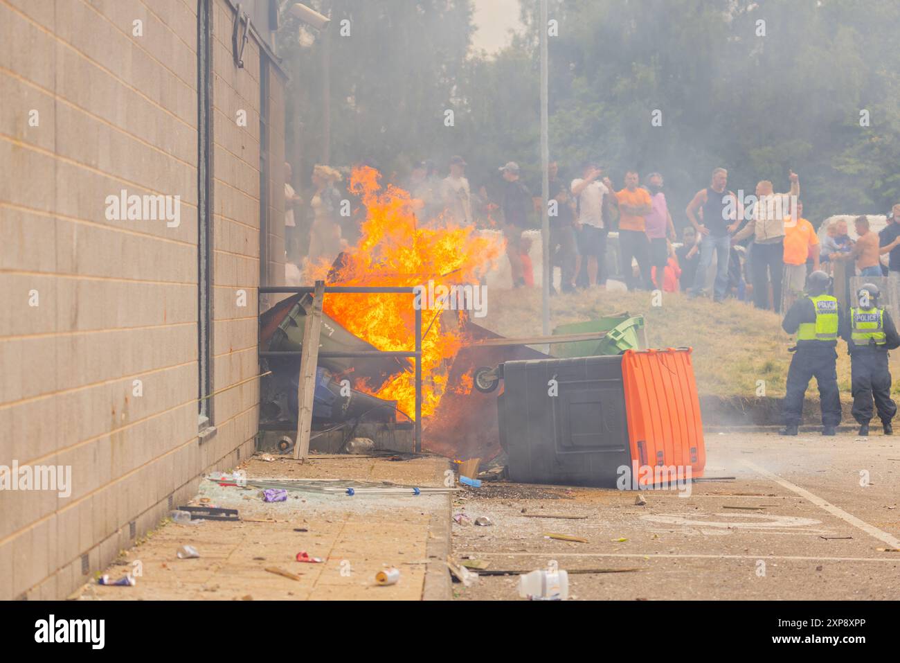 Rotherham, UK. 04 AUG, 2024. Rioters start a fire in a window as ...