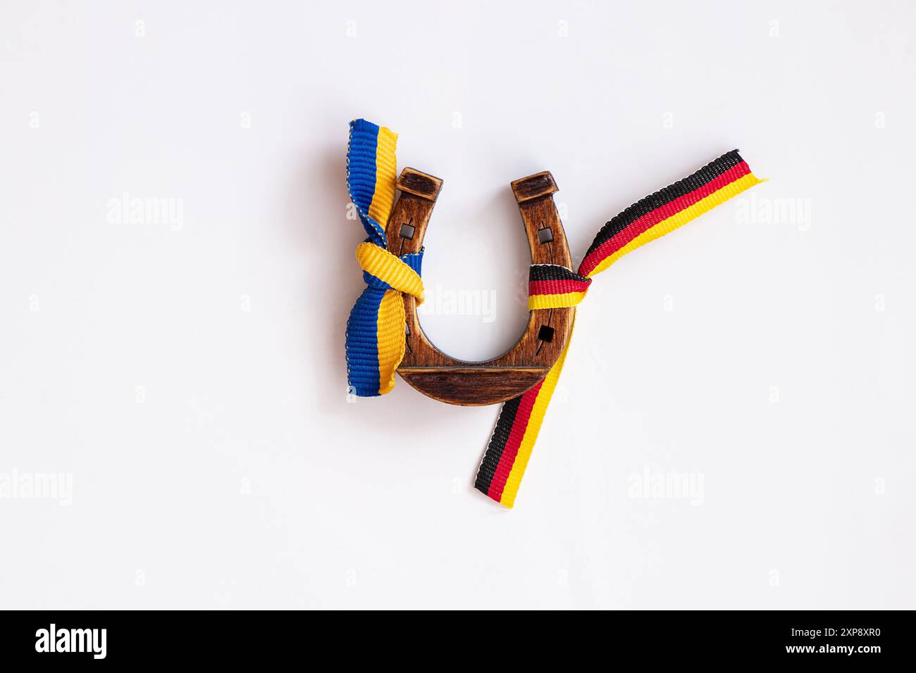 Wooden horseshoe tied with ribbon with Ukrainian flag and German flag ...