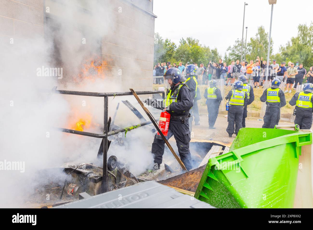 Rotherham, UK. 04 AUG, 2024. Police respond as rioters start a fire in ...