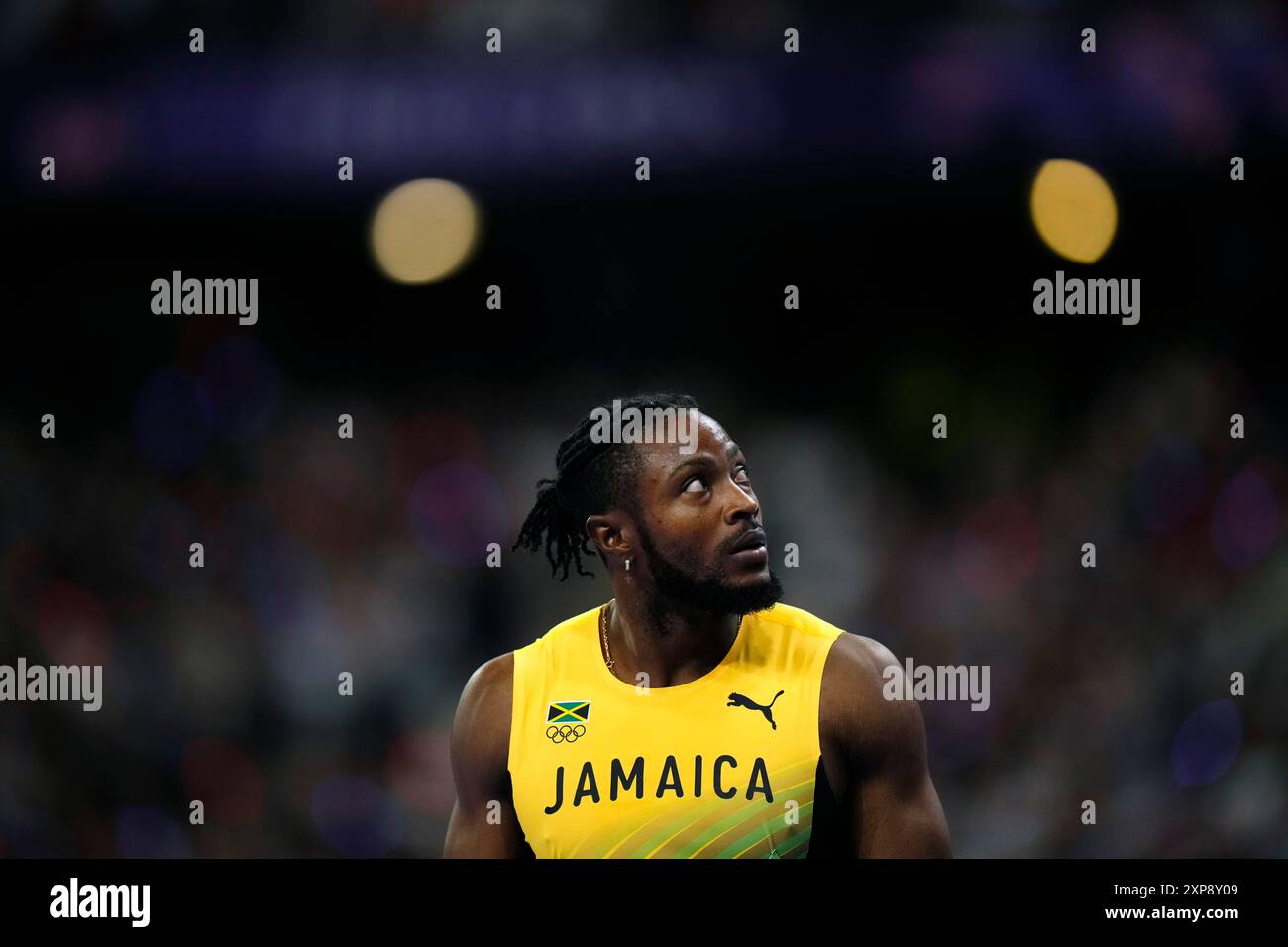 Kishane Thompson, of Jamaica, watches after finishing in second place ...