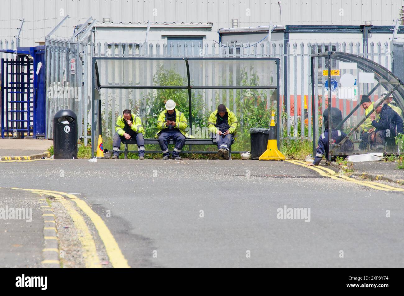 Construction works sat using phones during break time Stock Photo - Alamy