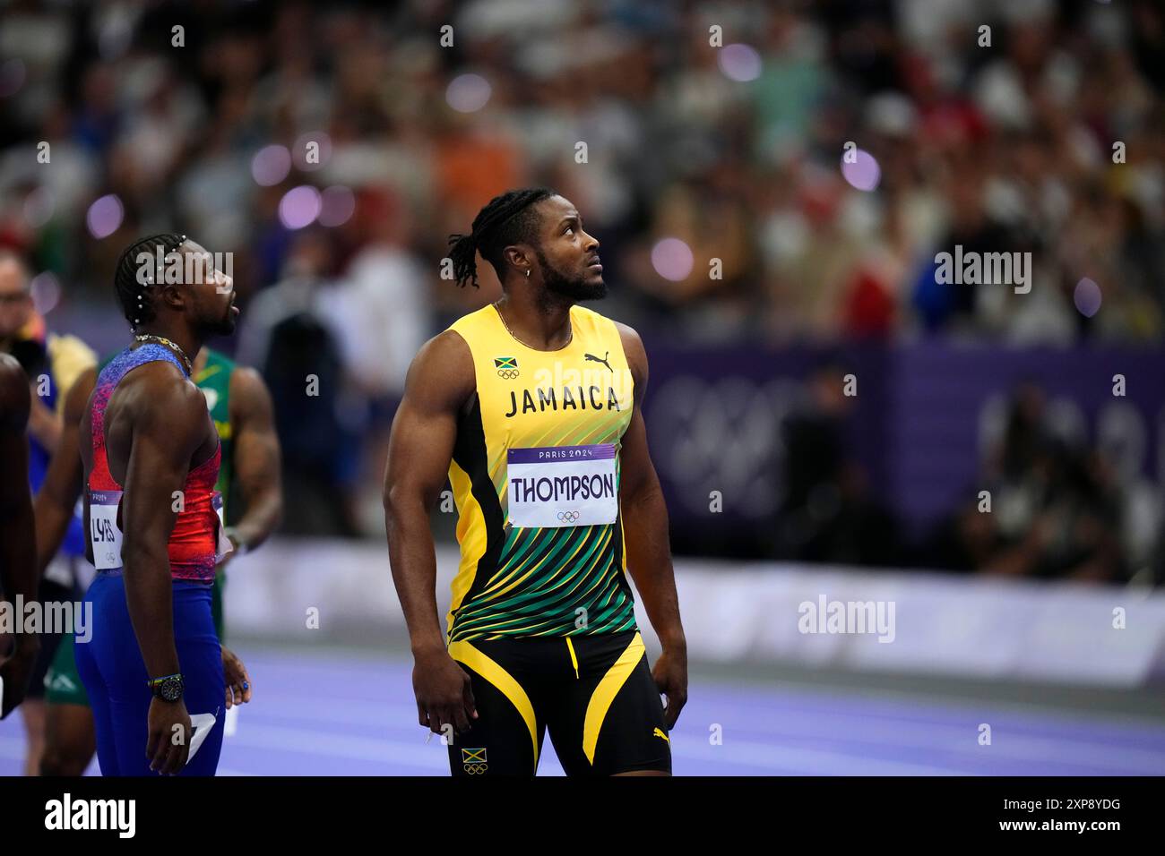 Kishane Thompson, of Jamaica, watches after finishing in second place ...