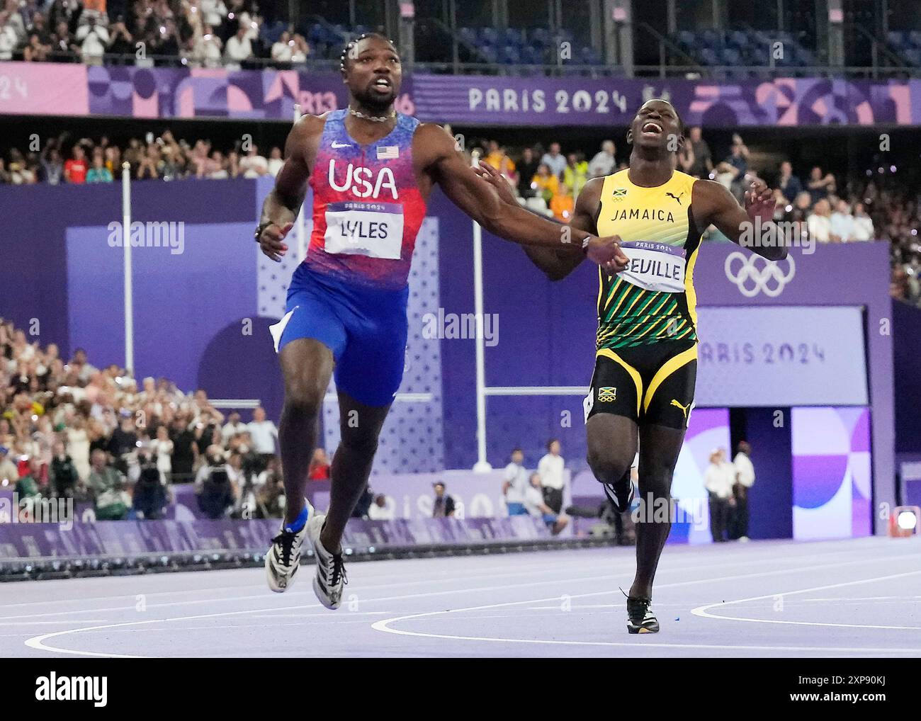 Paris, France. 04th Aug, 2024. Noah Lyles of the U.S. (L) crosses the finish line ahead of ...