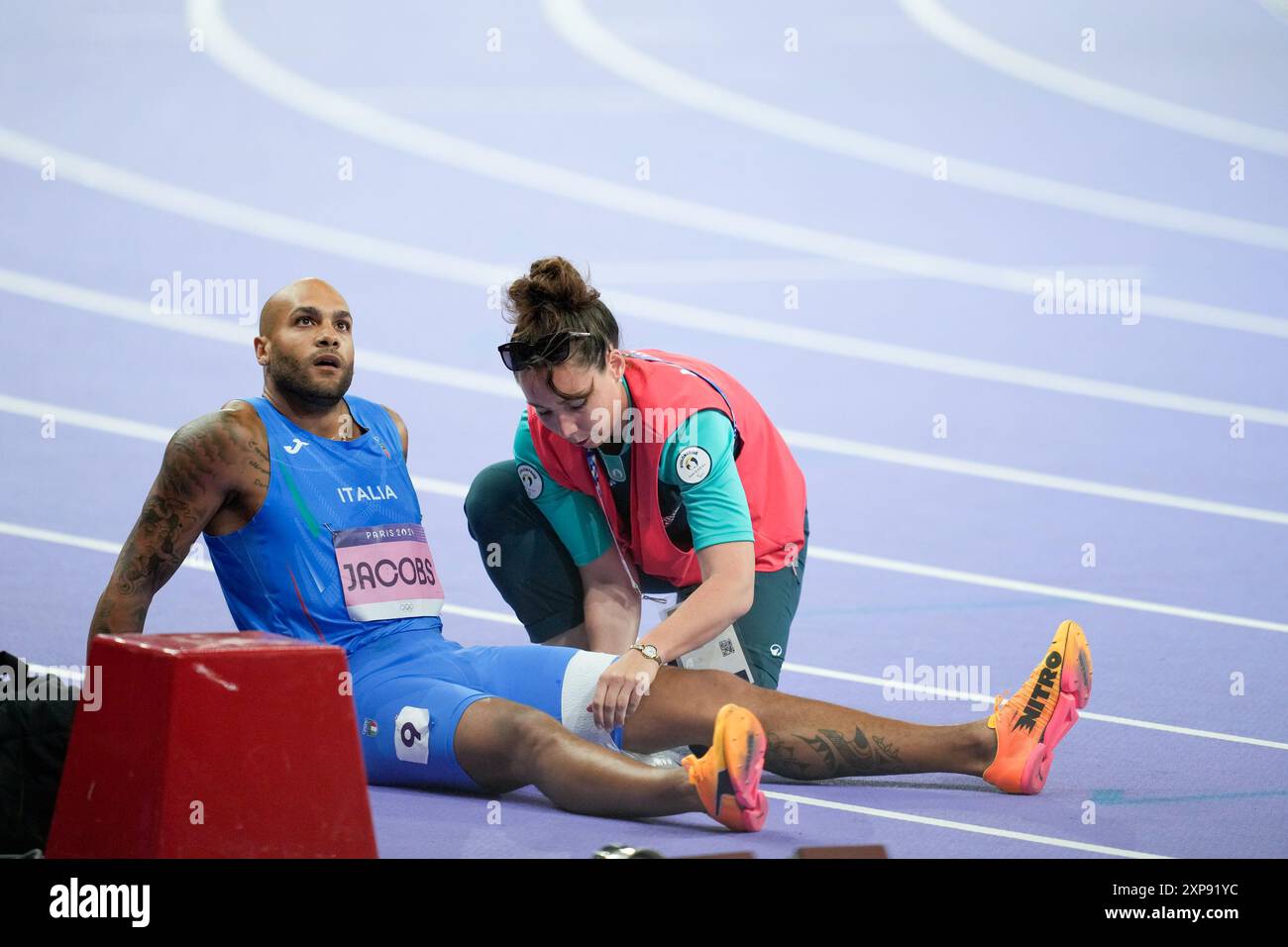 PARIS, FRANCE - AUGUST 4: Lamont Marcell Jacobs of Italy gets treated ...