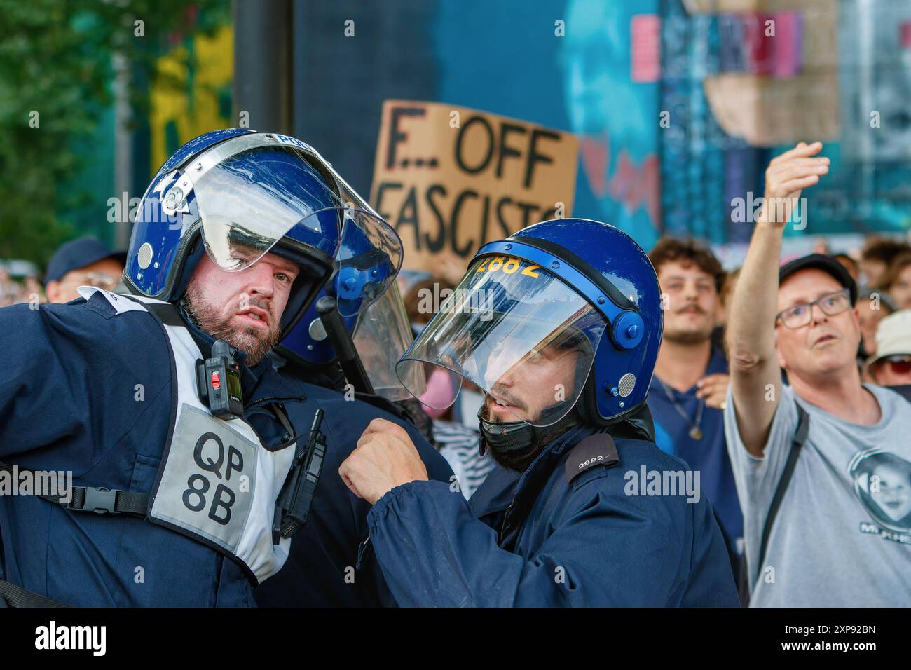 Bristol Riot - Police officers in riot gear talk to each other during ...