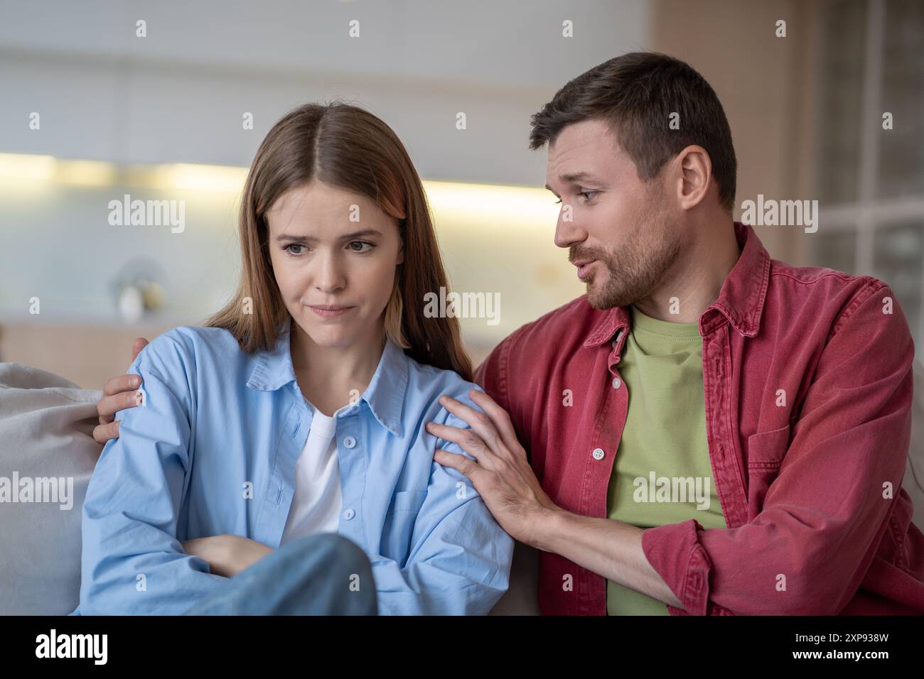 Offended girl, soothing man hug girlfriend by shoulders saying ...