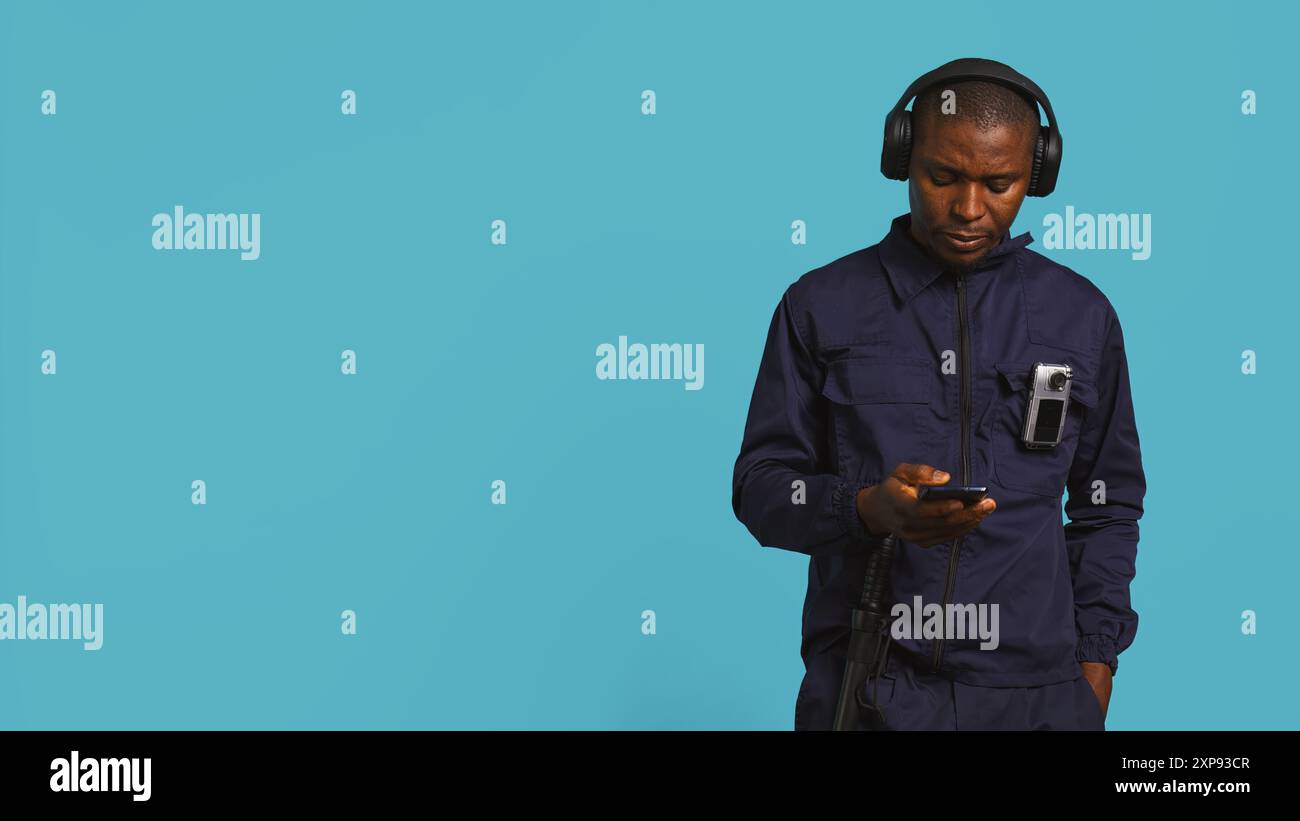 Security guard equipped with bodycam listening music, taking break from ...