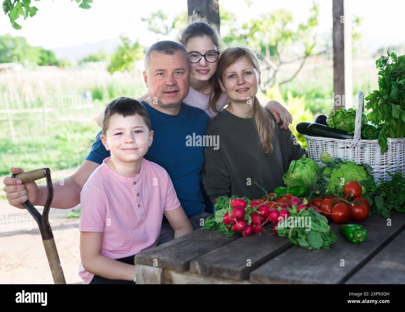 Family posing in garden with picked vegetables Stock Photo - Alamy