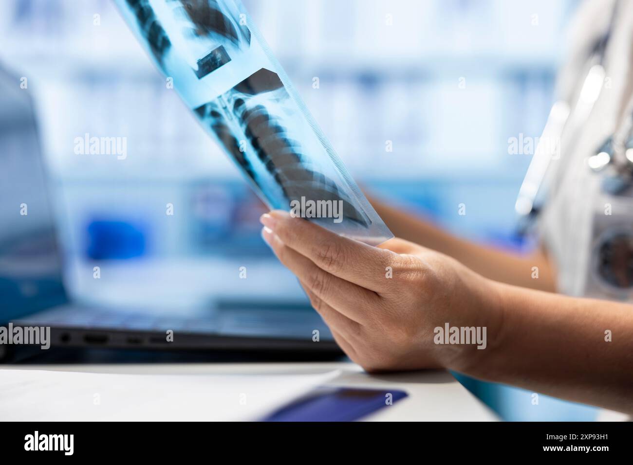 In a treatment center, physician reviewing radiography data on scan and putting diagnostic ...